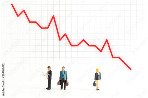 Miniature People Standing Below A Graph Fluctuating Up And Down Stock