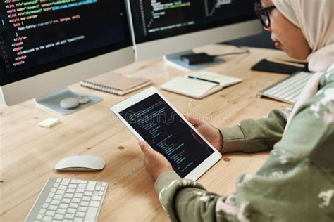 Close Up Of Young Muslim Female Programmer Looking Through Coded Data