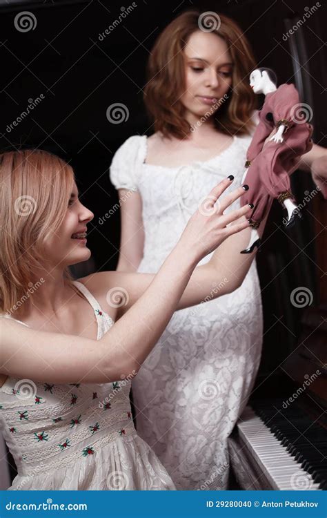 Women Playing With Doll Stock Photo Image Of Pair Holding