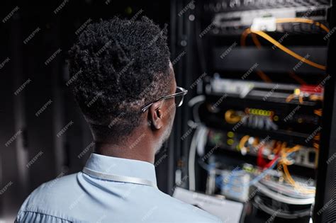 Premium Photo Back View Network Engineer Working With Server Cabinet In Data Center