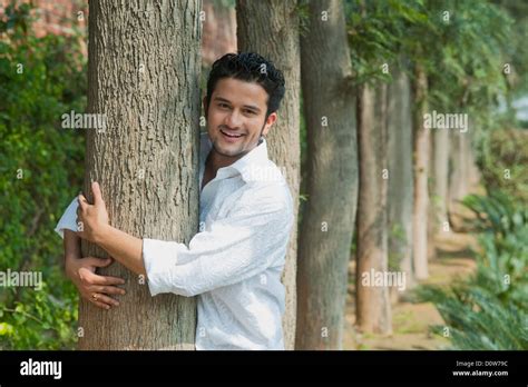 Man Hugging A Tree And Smiling Stock Photo Alamy