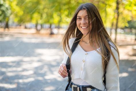 Premium Photo Smiling Female College Student Walking Outdoor In A Park