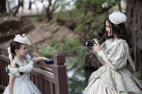 Two Sister Wearing Vintage Clothes Are Having Fun Happily In A Large