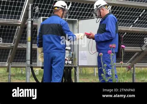 Two Service Engineers Or Electrician Working On Checking Transformer Two Service Engineers Or Electrician Working On Checking Transformer