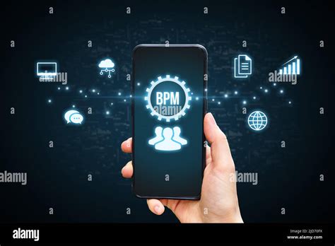 Concept Bpm Or Business Process Management Holographic Icons By The Phone In The Hands Of A