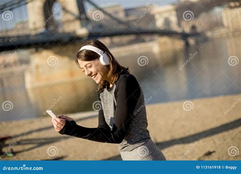 Woman Making A Pause After The Exercise And Using Mobile Phone Stock