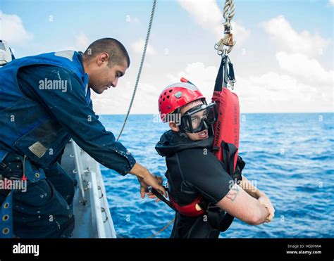 Search And Rescue Swimmer Quartermaster 2nd Class Riley Knox Right Is