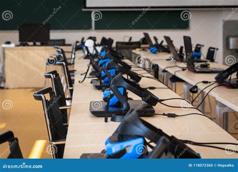 Close Up Of Many Virtual Reality Vr Sets In A Classroom Headset Controller And Computer