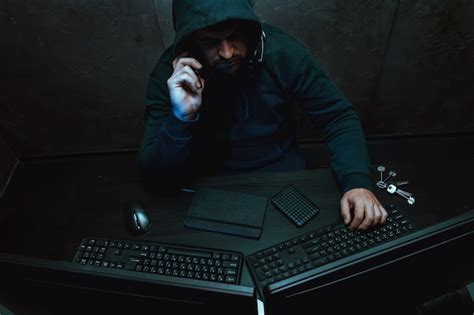 Premium Photo Hacker Programmer Using Computer In Dark Room