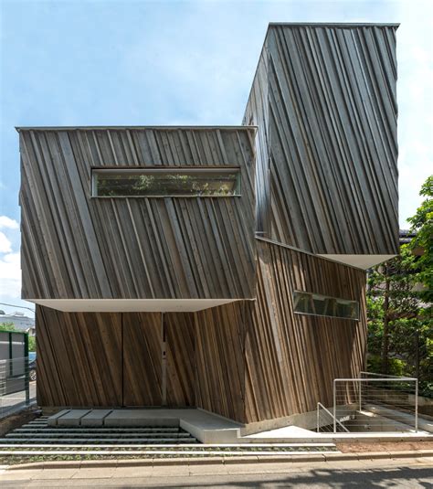 kyodo house by sandwich has wood facade and indoor swing