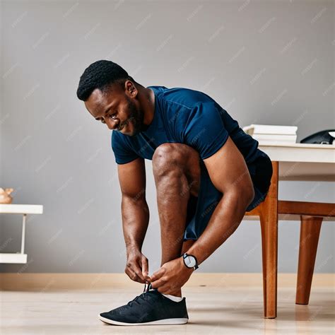 Premium Ai Image A Man Ties His Shoelaces On The Ground