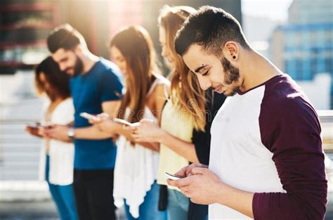 Staying Connected A Handsome Young Man Sending A Text Message While