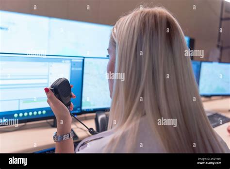 Security Guard Monitoring Modern CCTV Cameras In Surveillance Room Female Security Guard In
