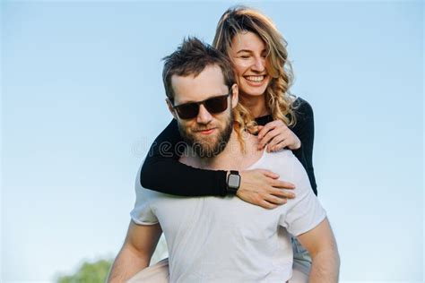 Wife Riding On Husband They Are Enjoying Their Summer Vacation In Countryside Stock Image