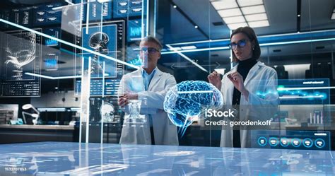 Two Neuroscientists Working With Computerpowered Vfx Hologram Of Human Brain And Nervous System