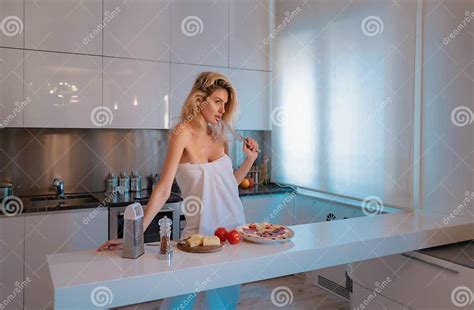 Blond Beautiful Girl Cooking In Kitchen Doing Breakfast With Healthy