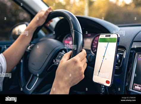 Woman Using Navigation App On Smartphone While Driving A Car Stock Photo Alamy