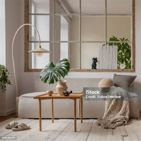 모듈식 소파 큰 창문 세련된 램프 나무 커피 테이블 원형 테이블 등나무 의자 베개 식물 및 개인 액세서리가 있는 개방형 공간