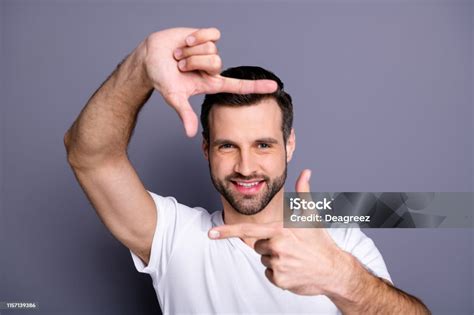 매력적인 사랑스러운 긍정적 인 쾌활한 사랑스러운 사람의 초상화 사람들은 기뻐하는 내용이 흰색 빛옷을 입고 흰색 빛0 색의 옷을 입고 회색 배경을 만듭니다 미소에 대한 스톡