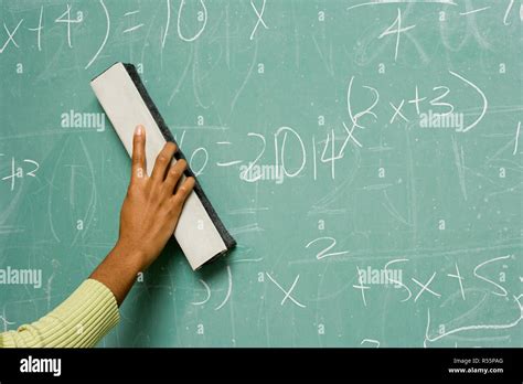 Person Removing Formulas From The Blackboard Stock Photo Alamy