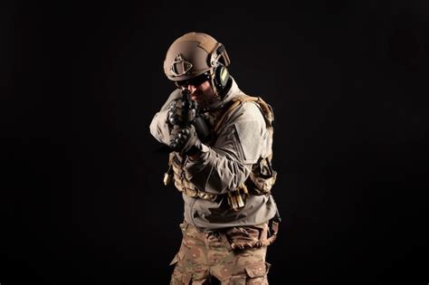 Premium Photo Portrait Of Special Forces In A Military Uniform With Weapons At Night