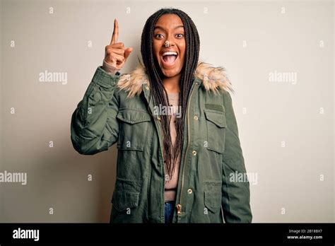 Young African American Woman Wearing Winter Parka Coat Over Isolated