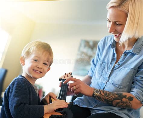 Moms Teaching Me A New Tune Portrait Of A Mother And Son Having Fun