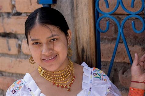 Premium Photo Closeup Of Indigenous Teenager From Otavalo Smiling At The Camera Tied To A Blue