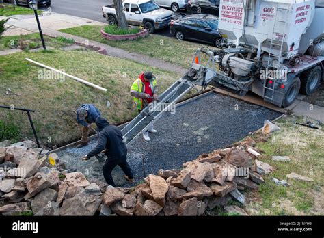 Workers Pouring A New Driveway At A Home In Maryland USA Concrete Is Laid Over Wire Mesh And