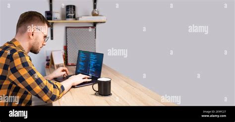 Portrait Of Male Programmer Using Programs Computer Code In A Bright Home Concept Programmer
