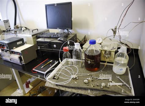 workstation in a real science laboratory quite messy including computer note pad pen sample