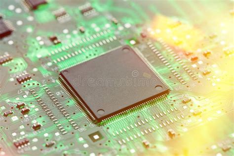 Backlit Green Printed Circuit Board With The Processor Is Burning Orange Background Texture