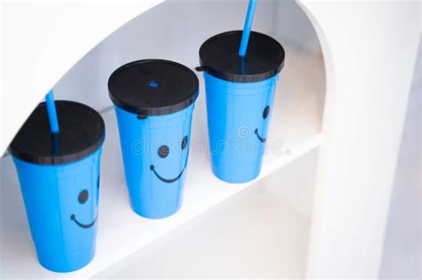 Cute Blue Plastic Glasses With Smiley Faces Placed On A White Cabinet Shelf Stock Image Image
