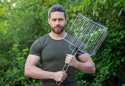 Photo Of Man With Barbecue Grill Utensil Outdoor Stock Image Image Of Cookware Barbecuing