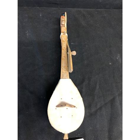 A Single Stringed Bowed Instrument Elaborately Hand Carved Body With A