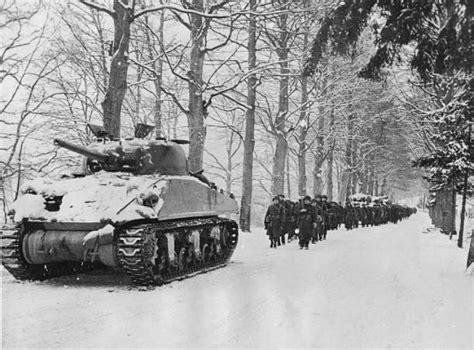 Infantrymen And Tanks Of The 75th Us Division Move Forward Over A Snow