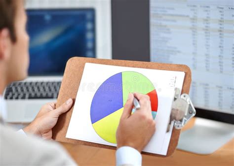Gaining Insight Through Graphs Over The Shoulder Shot Of A Businessman Looking At A Graph