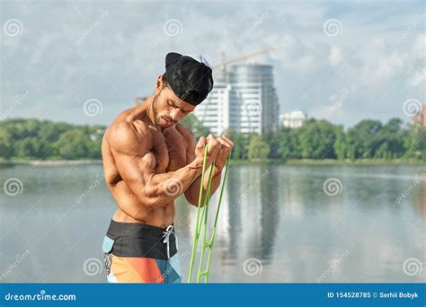 Muscular Man Doing Power Exercises With Rubber Expander Stock Image Image Of Nature Model