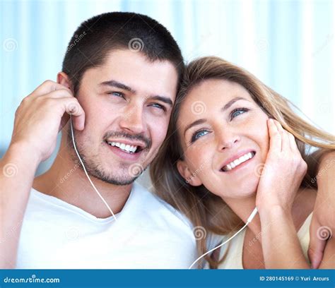 Enjoying Their Favourite Tunes Attractive Young Couple Listening To