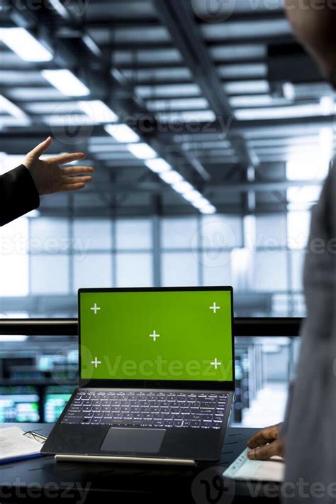 Employees In Data Center Using Green Screen Mockup Laptop Analyzing
