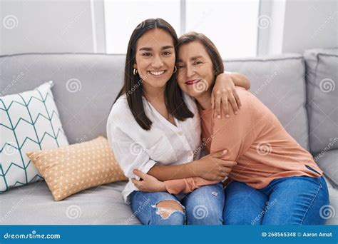 Two Women Mother And Daughter Sitting On Sofa Together At Home Stock