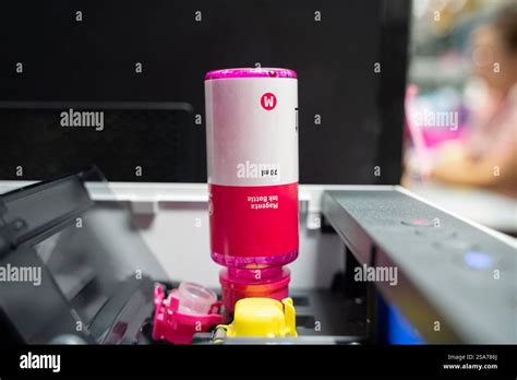 Closeup Refilling Ink Into A Red Ink Tank Printer At Office Cartridges And Containers Of