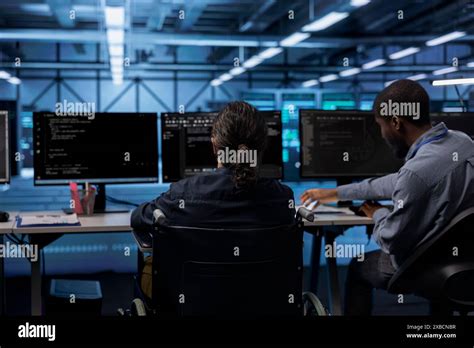 Person With Paraplegia Working In Inclusive Workplace Typing Data On Pc