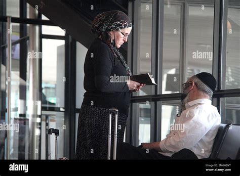 A Jewish Couple Reading While Writing In The Terminal Of An