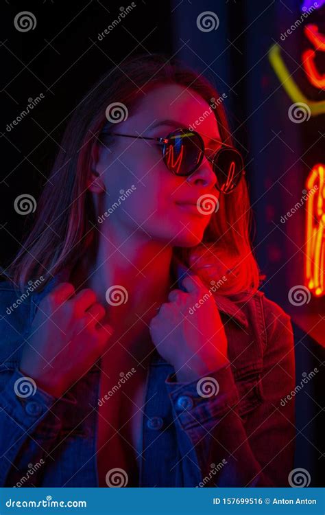 Creative Sexual Portrait Of A Girl In Neon Lighting With Glasses Stock