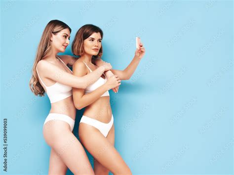 Fashion Portrait Of Two Young Beautiful Women Attractive Carefree