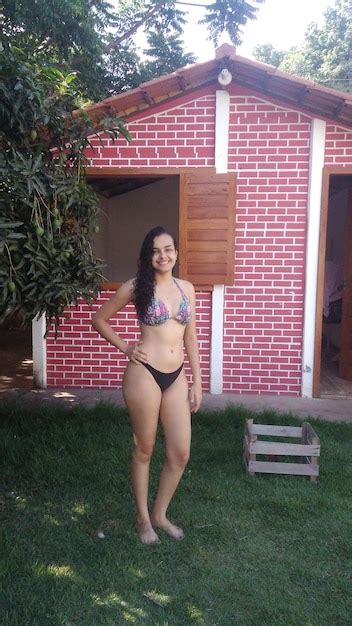 Premium Photo Portrait Of Smiling Woman In Bikini Standing On Field