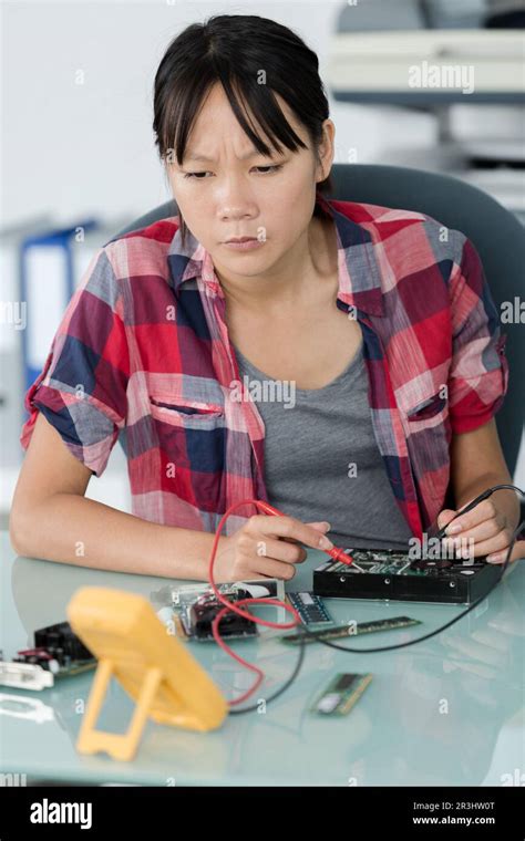 Female Asian Computer Technician Using Multimeter Stock Photo Alamy