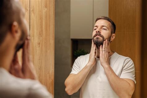 Premium Photo A Bearded Man Is Preparing To Shave His Beard While