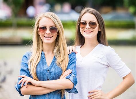 Premium Photo Portrait Of Two Cheerful Young Women In Sunglasses